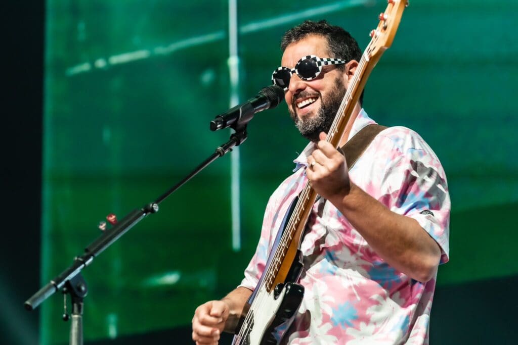 Adam Sandler playing guitar on recent comedy tour | Circling The News